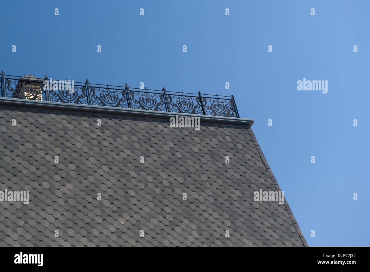part of the roof with tiles and metal fence Stock Photo - Alamy