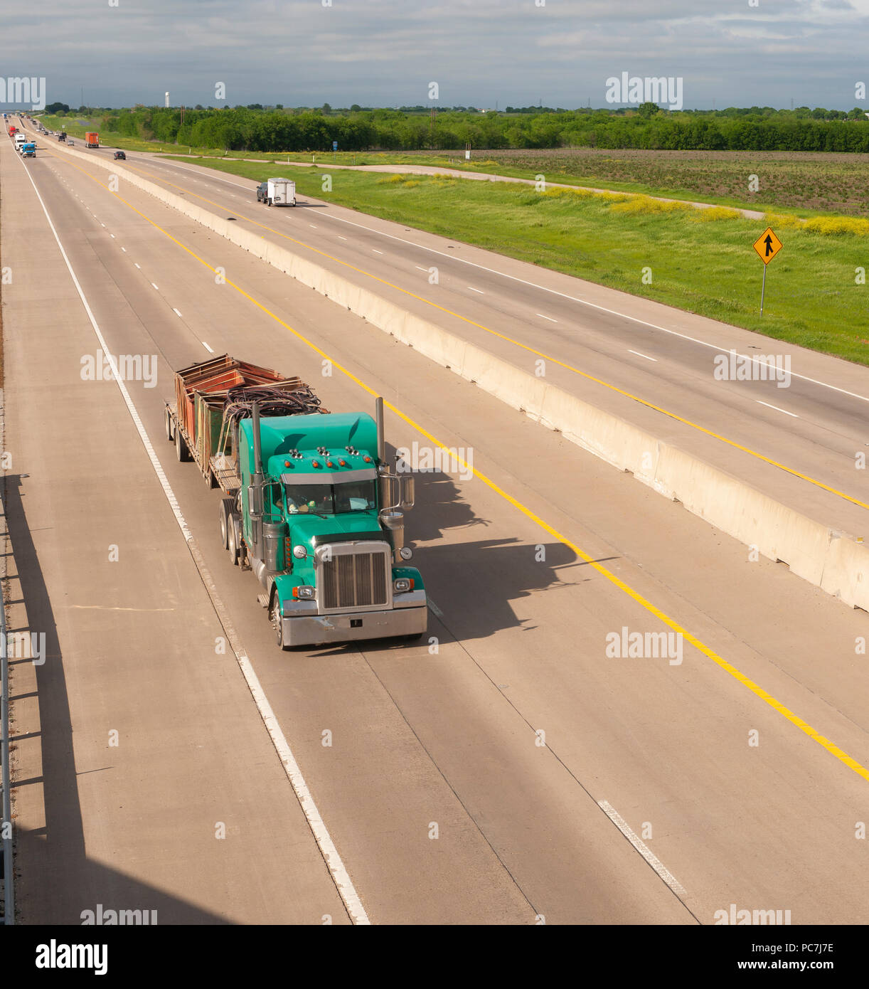 A bright and colorful 18 Wheeler motors down the highway with trailer ...