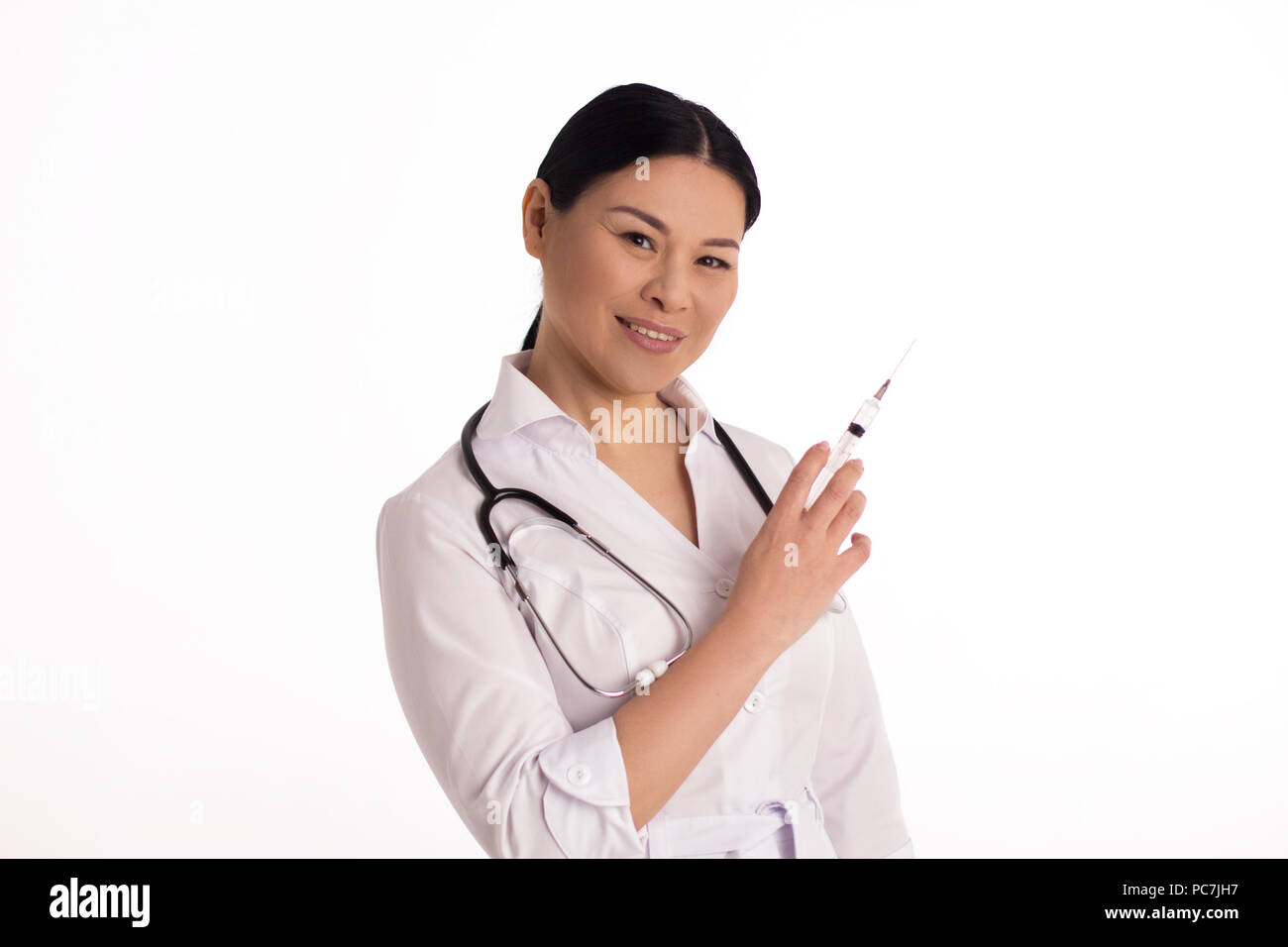 Studio shot of female doctor with syringe. Young beautiful female nurse ...