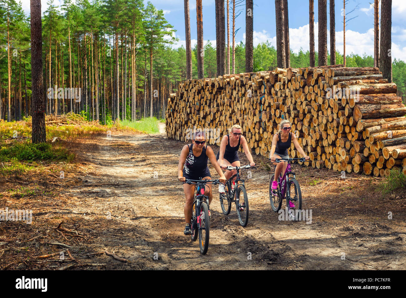 three women ride bicycles Stock Photo - Alamy