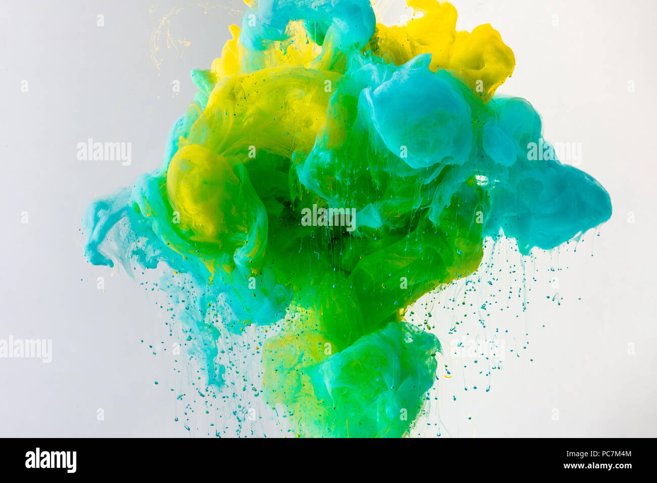 wallpaper with flowing turquoise, yellow and green paint in water ...