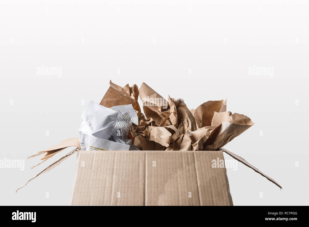 close up view of cardboard box with papers inside isolated on white ...
