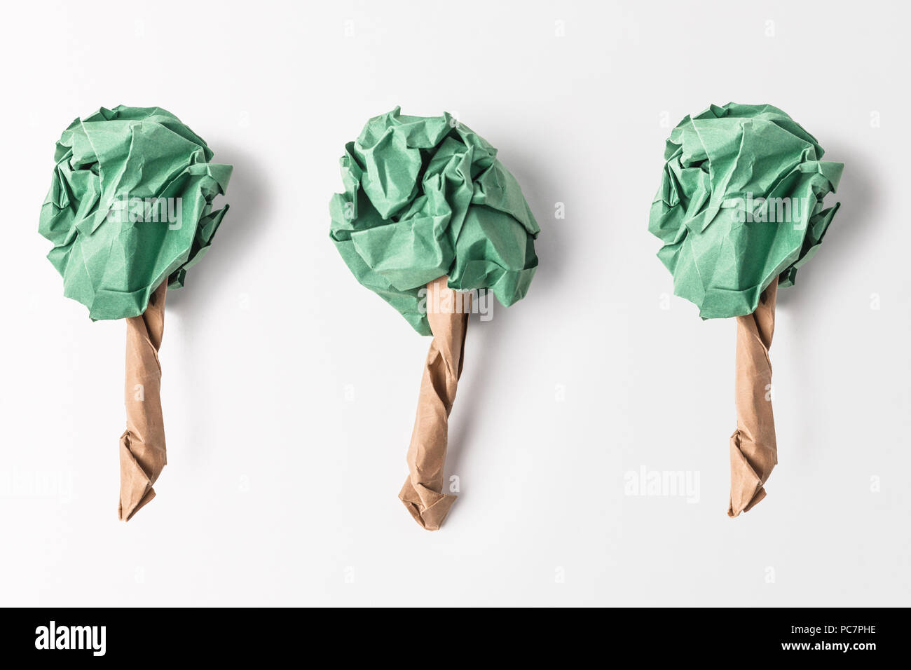 top view of paper made green trees isolated on grey, recycling and ...