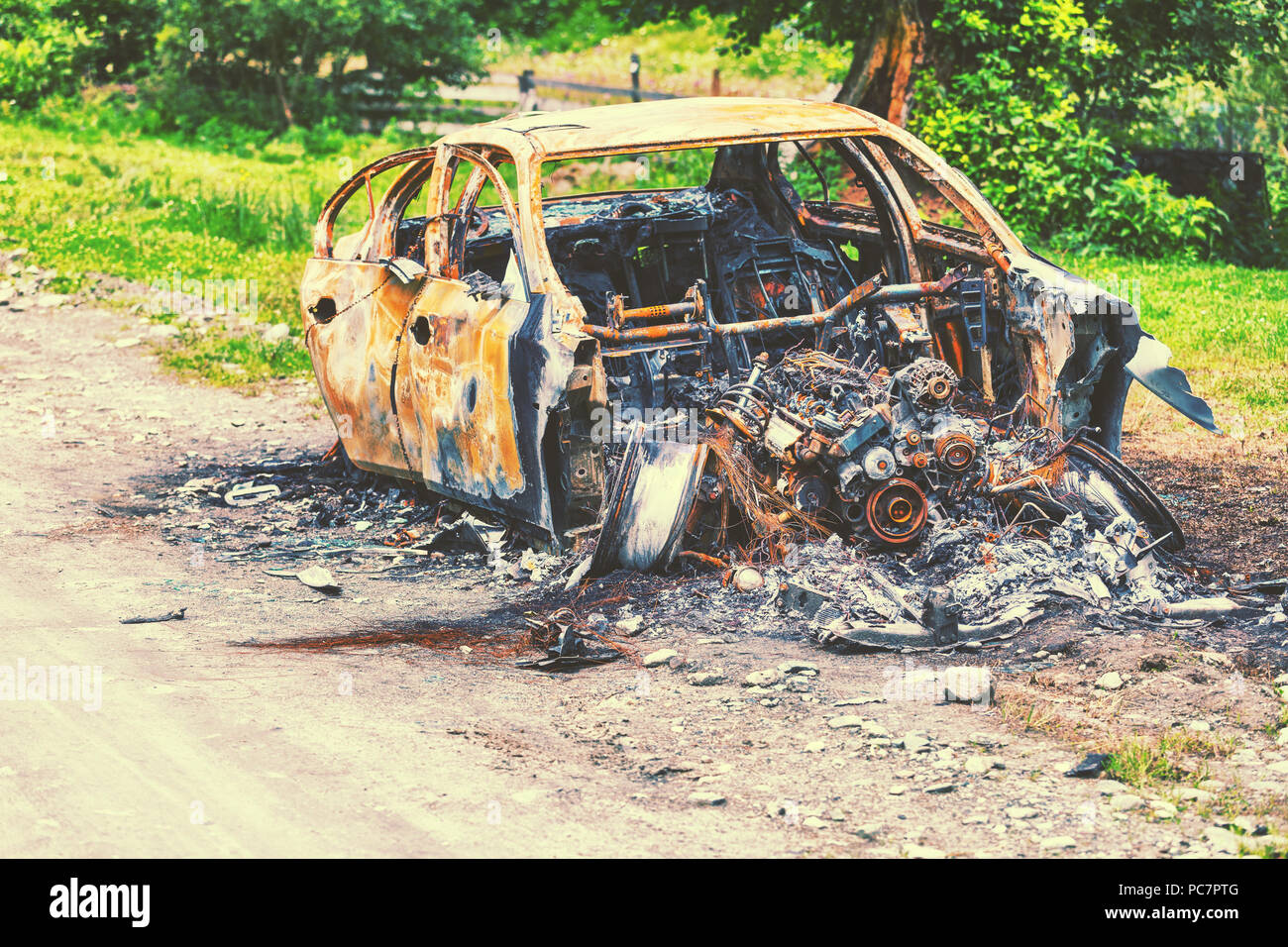 Vehicle burned to the metal near a country road Stock Photo - Alamy