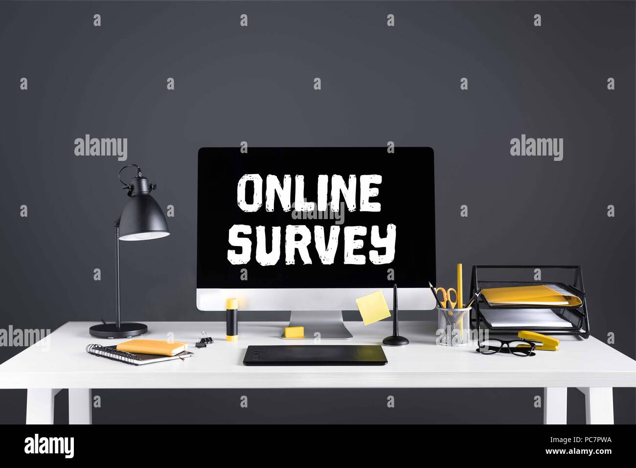 desktop computer with online survey inscription on screen, graphics ...