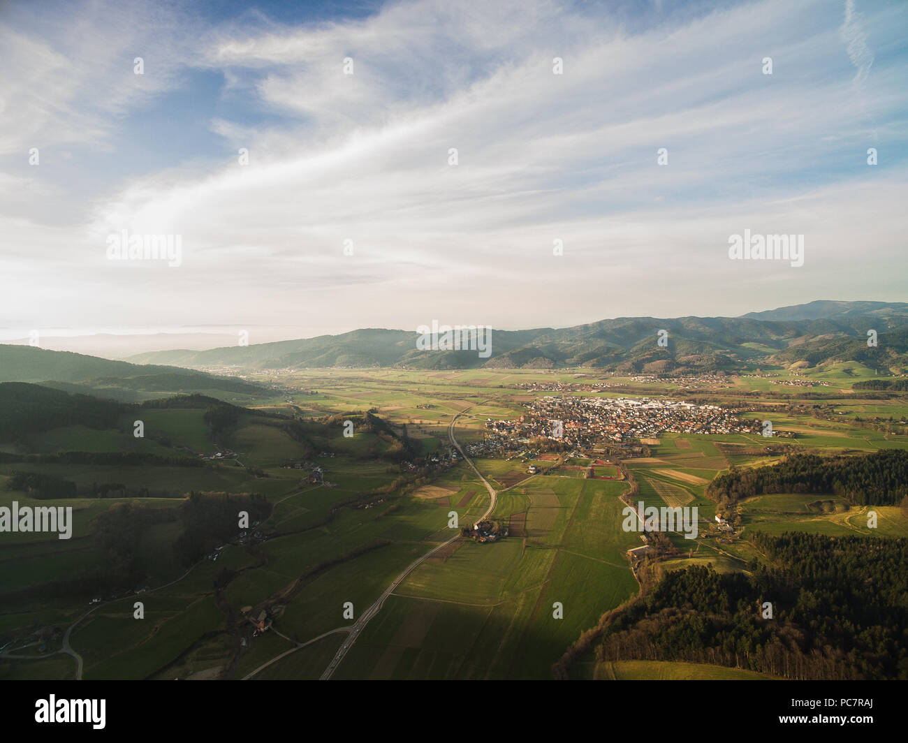 Aerial view of majestic landscape with field, hills and town in Germany ...