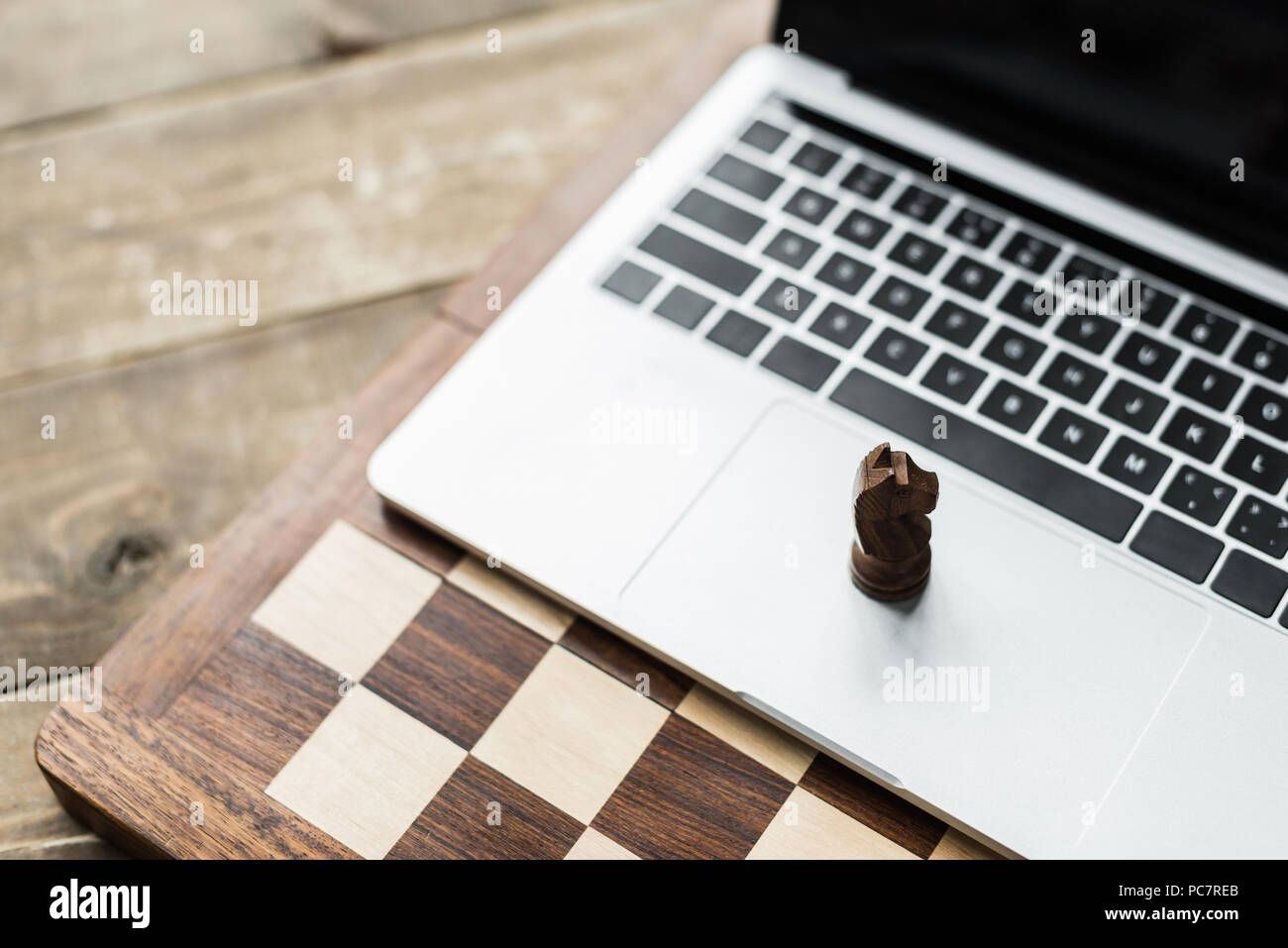 Close up of chess board and laptop with chess figure of knight Stock ...