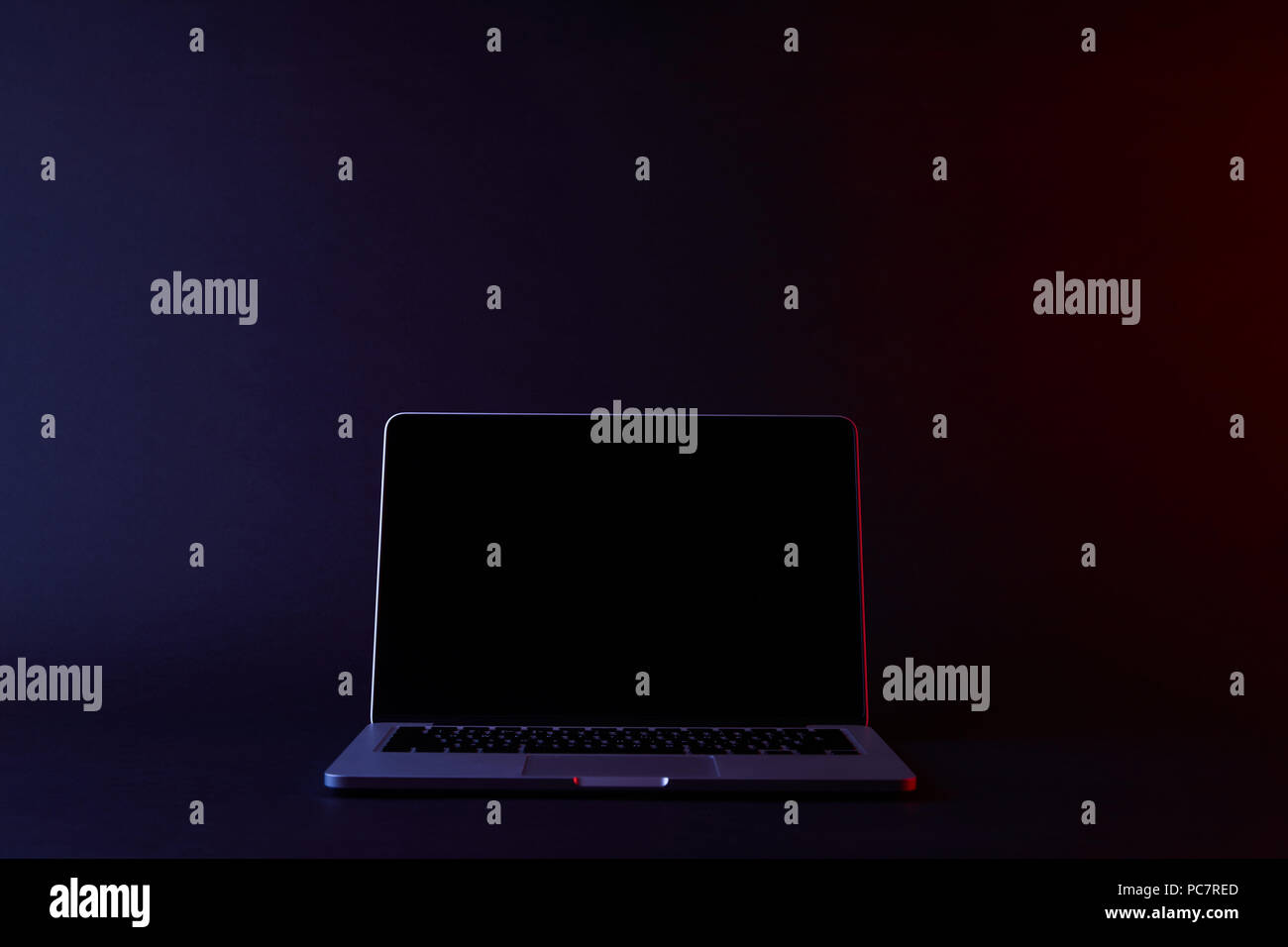 one turned off laptop with blank screen on dark Stock Photo - Alamy