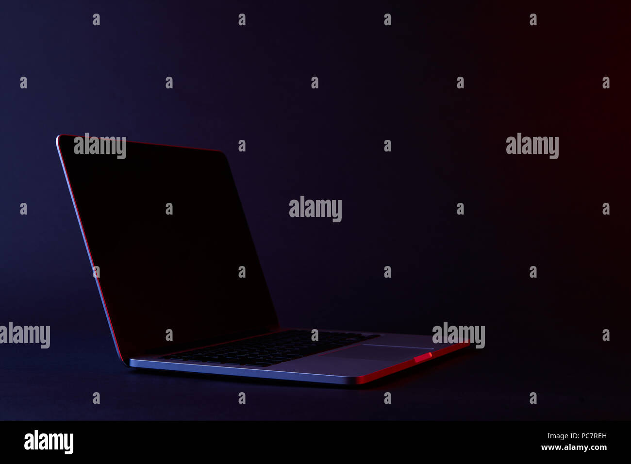 one turned off laptop with reflecting screen on dark Stock Photo - Alamy