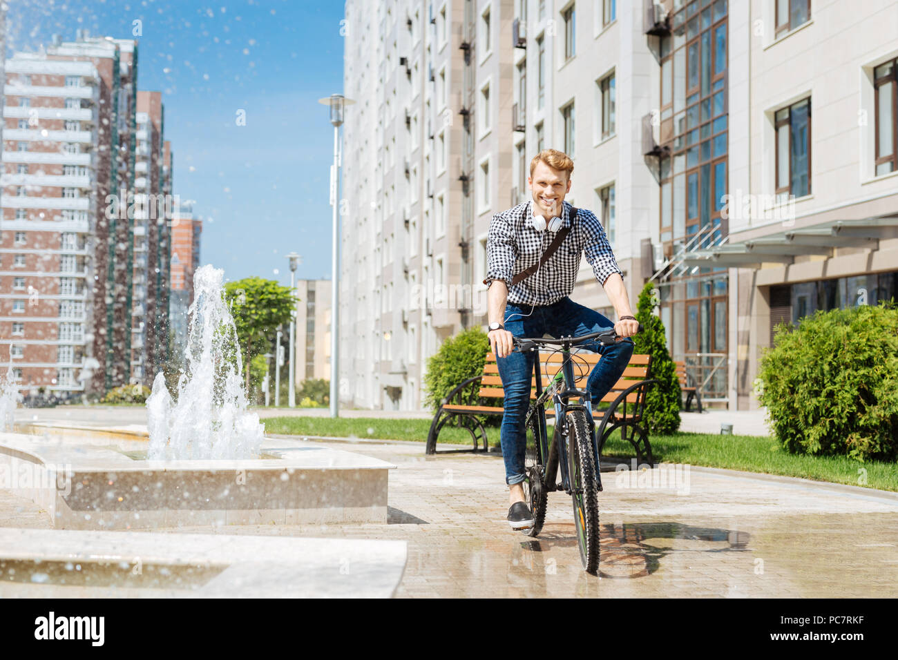 Joyful positive man riding his bicycle Stock Photo - Alamy Joyful positive man riding his bicycle Stock Photo - Alamy