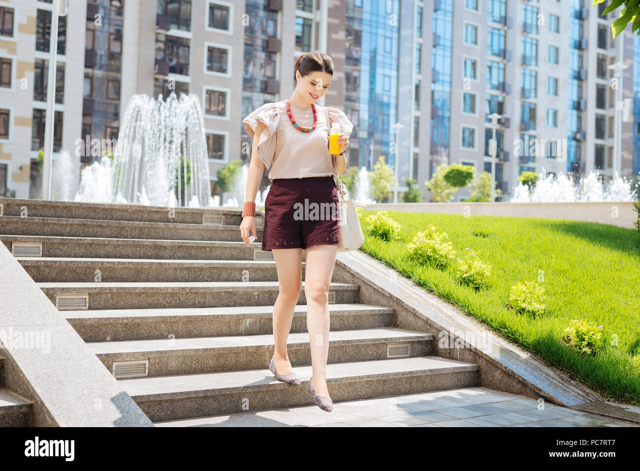 Woman walking down stairs hi-res stock photography and images - Alamy