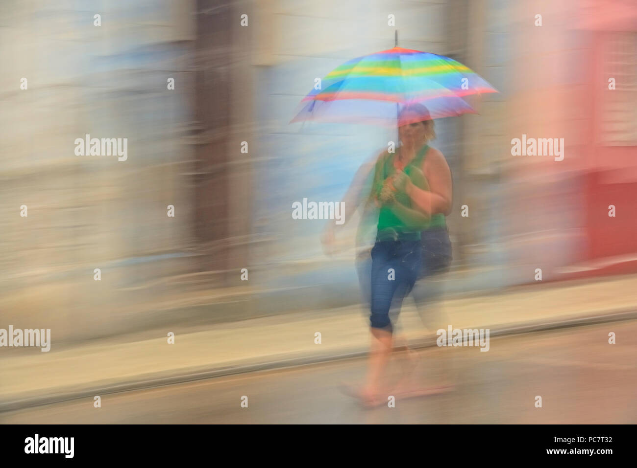 Street photography in central Havana- Pedestrian with umbrella on a ...