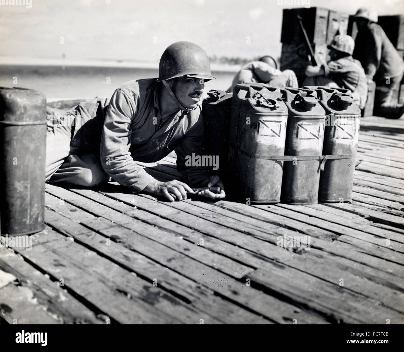 World War II Photo - US Marine under fire on pier at Tarawa Stock Photo ...