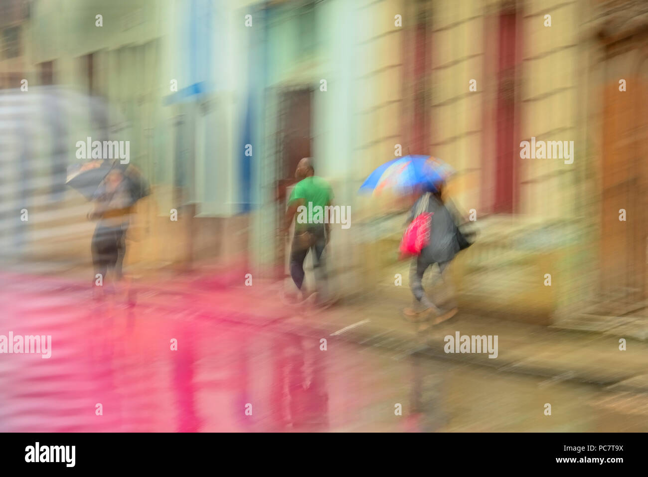 Street photography in central Havana- Pedestrian with umbrella on a ...