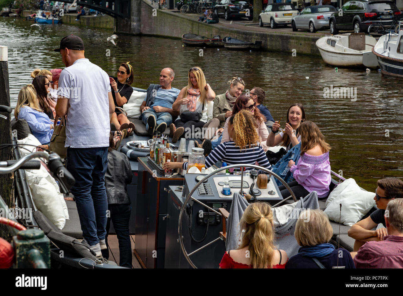 Tourists boating on the Amsterdam canals, Netherlands Stock Photo - Alamy
