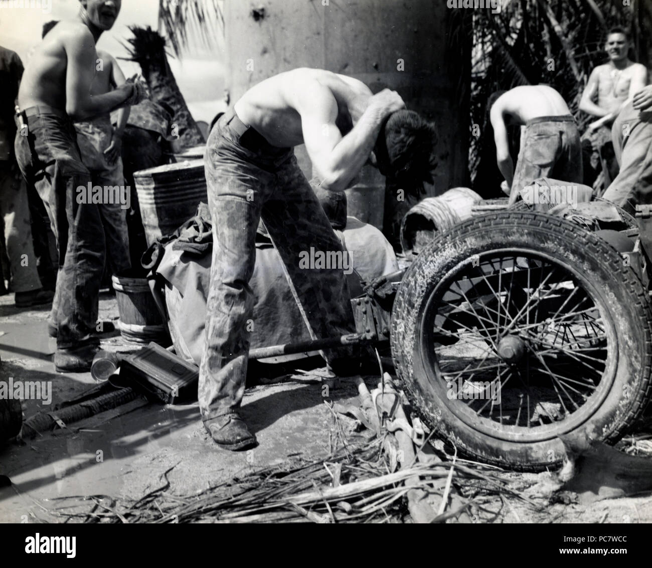 World War II Photo - U.S. Marines clean up after the battle of Tarawa ...