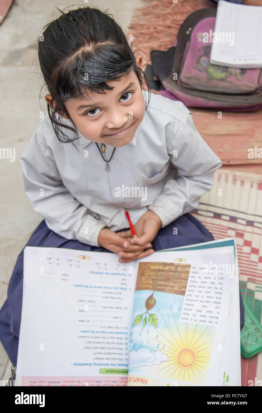 Girl sitting on the floor of her government primary school in uniform ...