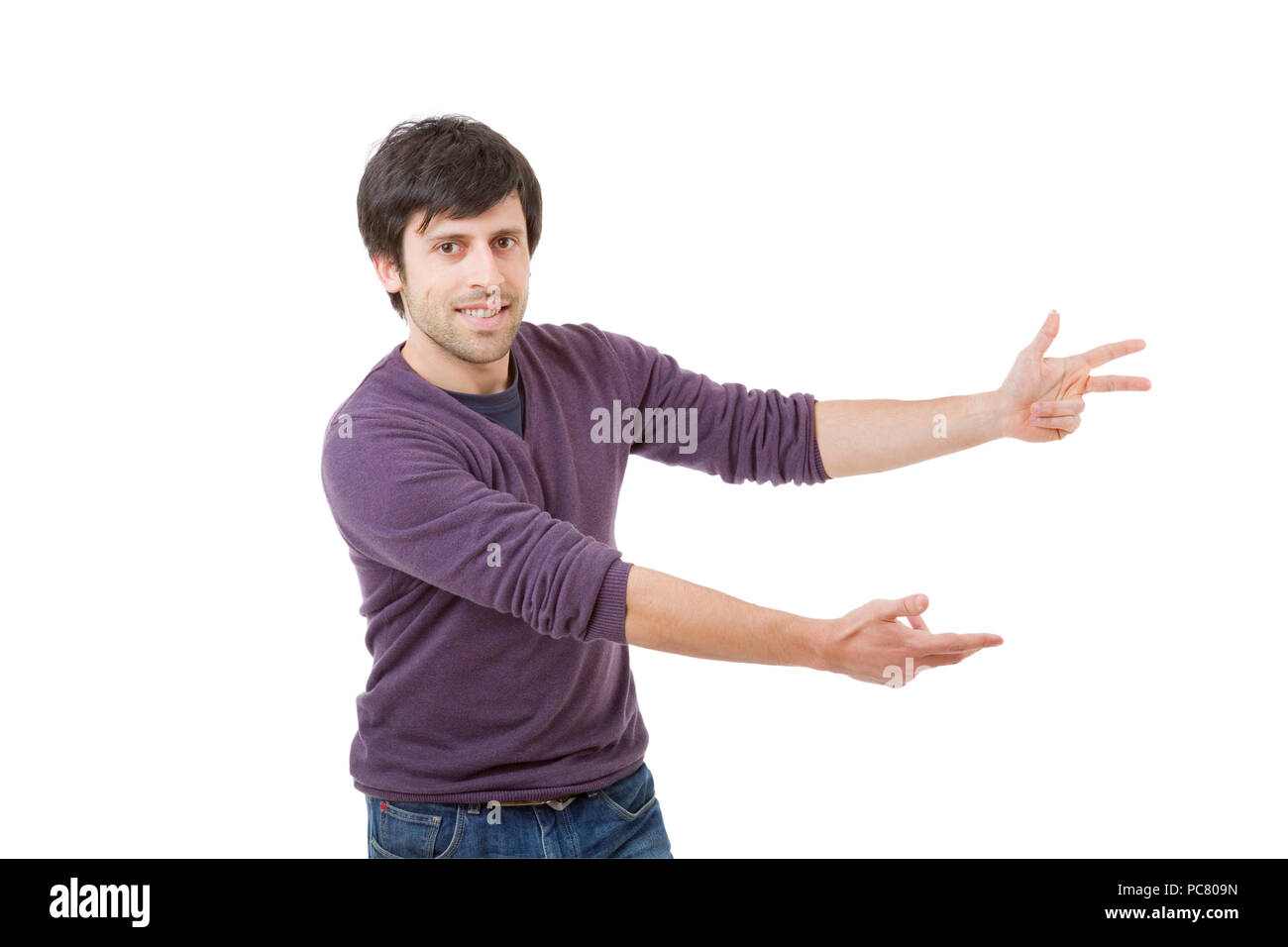 friendly young man pointing to his side. isolated on white background ...