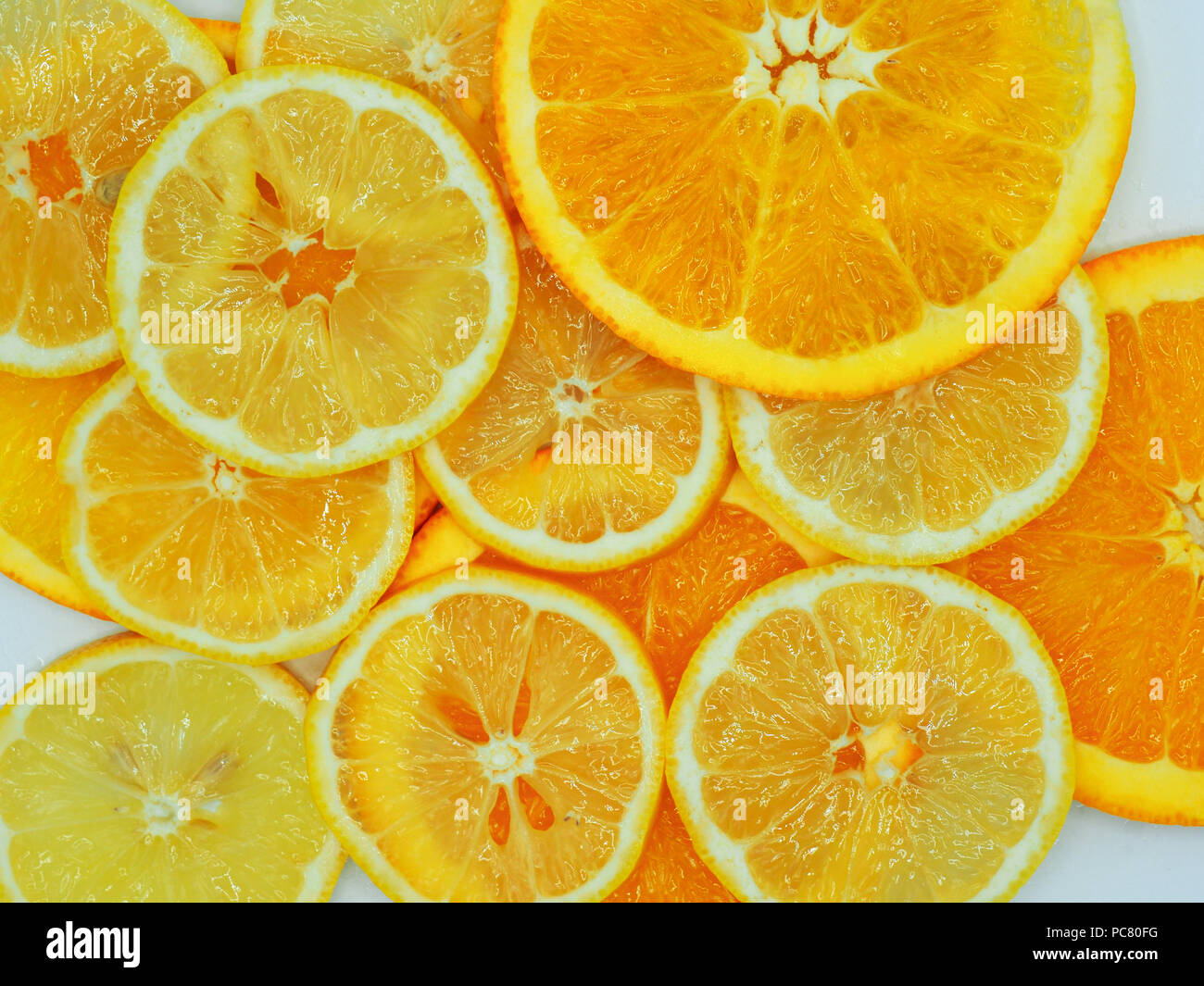 Slices of fresh orange and lemon texture background Stock Photo - Alamy