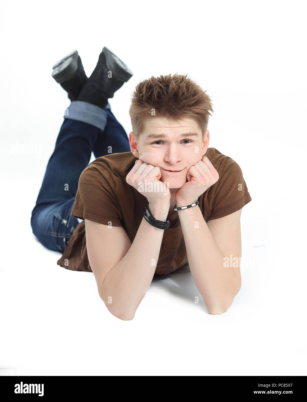 closeup. modern guy lying on the floor and looking at camera Stock ...