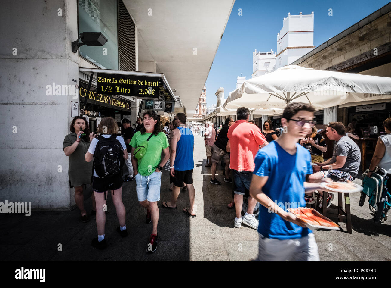 Tourists and locals at the beautiful and historic streets of Cadiz ...