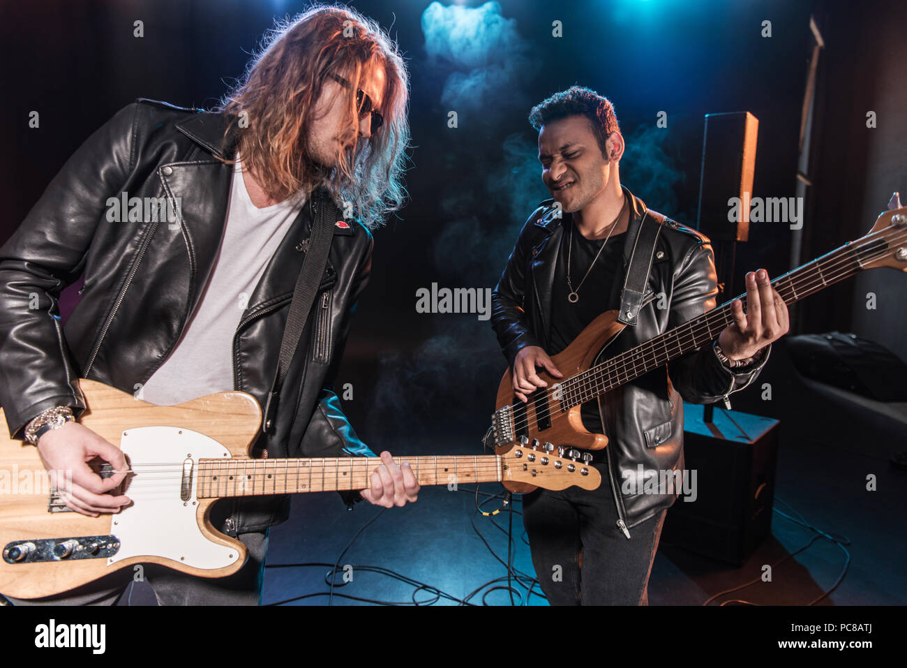 Electric guitar players performing hard rock music on stage Stock Photo ...
