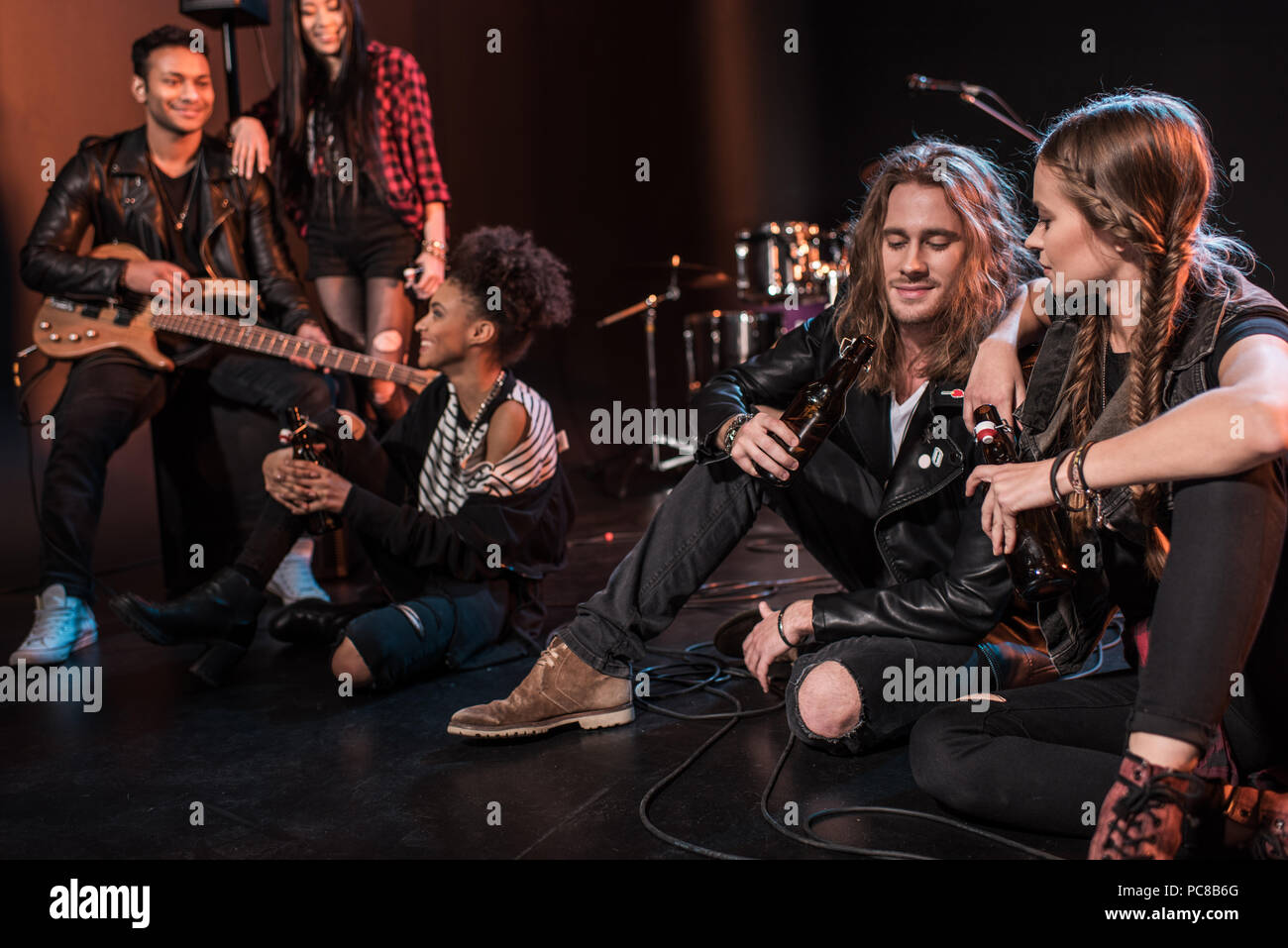 Young rock and roll band drinking beer after concert on stage Stock ...