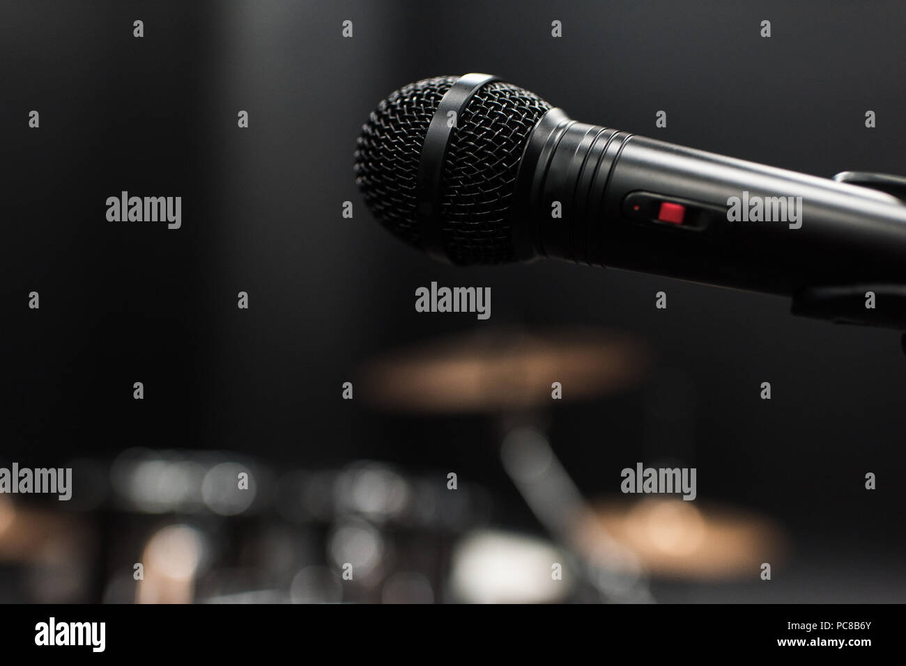 Close-up view of black electric microphone on empty stage Stock Photo ...