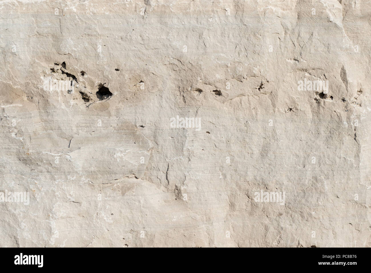 Closeup limestone rock face showing weathered strata for a geological ...