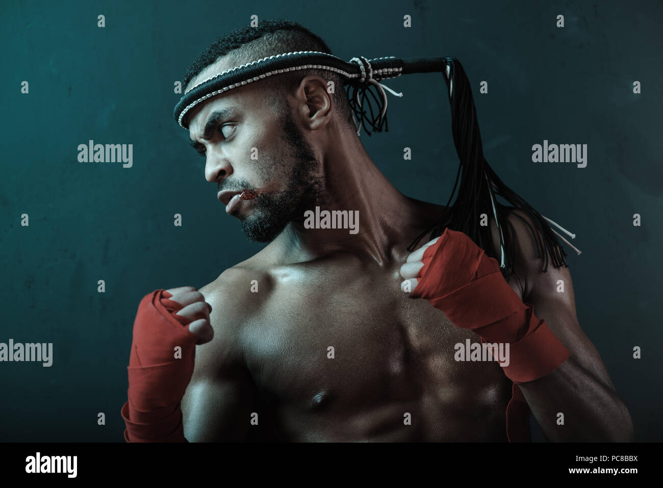 Close-up portrait of determined Muay thai fighter with blood on face ...