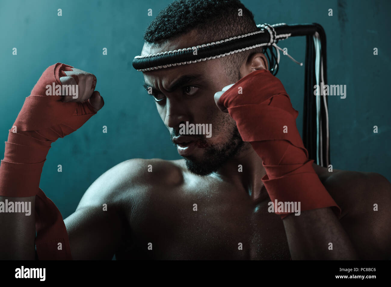 Close-up portrait of aggressive young Muay thai boxer training thai ...