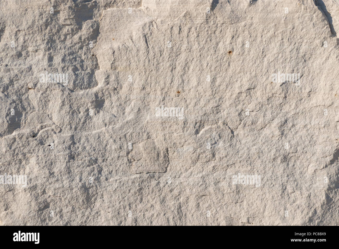 Closeup limestone rock face showing weathered strata for a geological ...