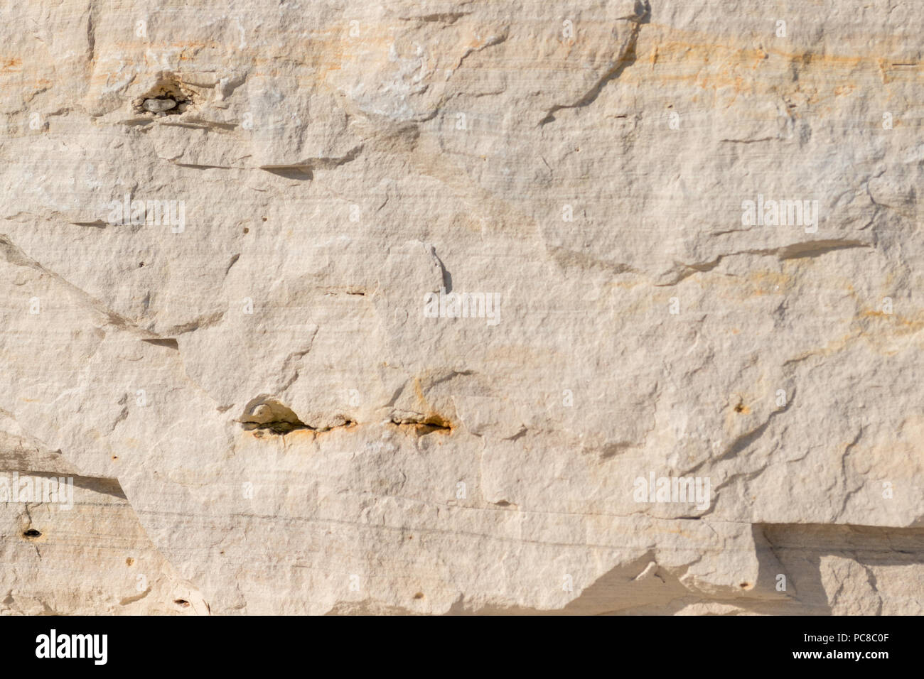Closeup limestone rock face showing weathered strata for a geological ...