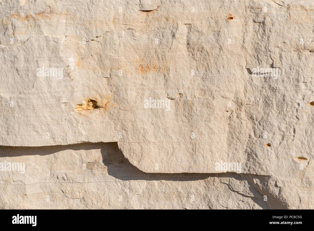 Closeup limestone rock face showing weathered strata for a geological ...