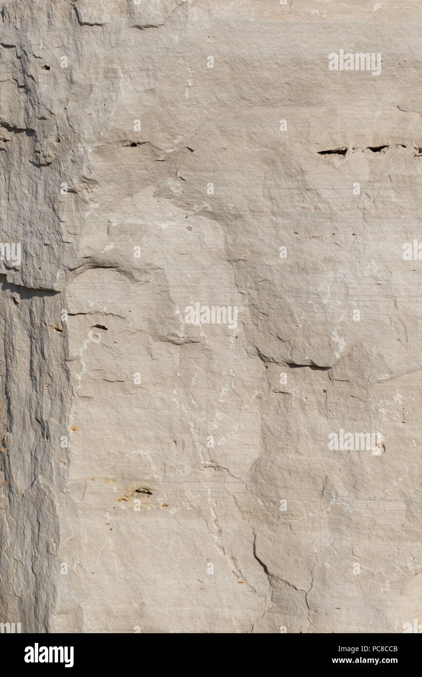 Closeup limestone rock face showing weathered strata for a geological ...