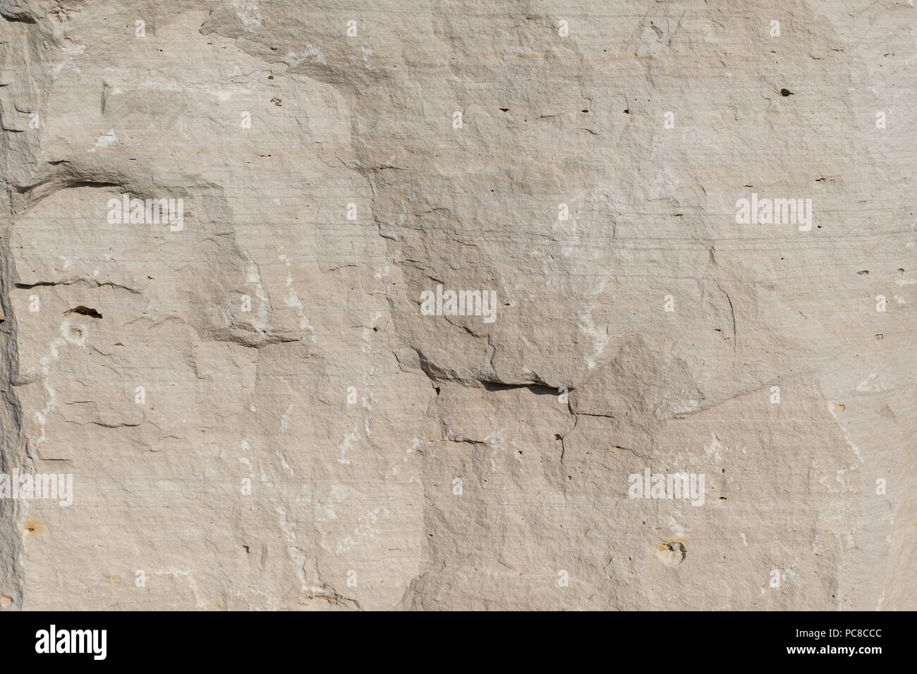 Closeup limestone rock face showing weathered strata for a geological ...