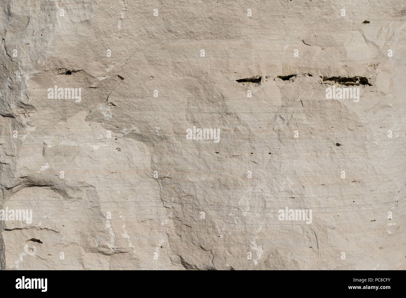 Closeup limestone rock face showing weathered strata for a geological ...