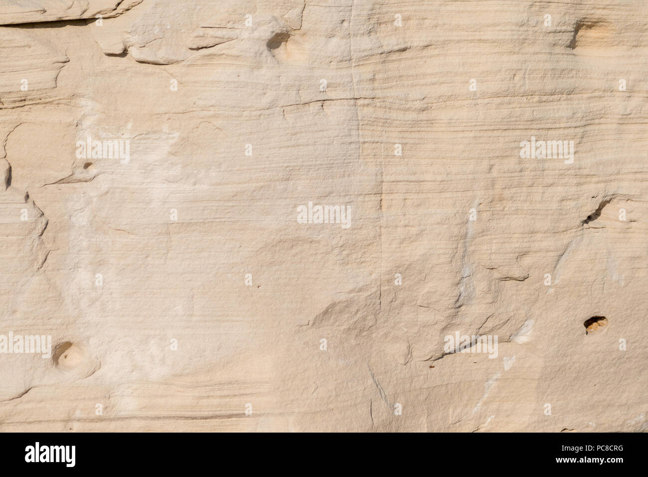 Closeup limestone rock face showing weathered strata for a geological ...
