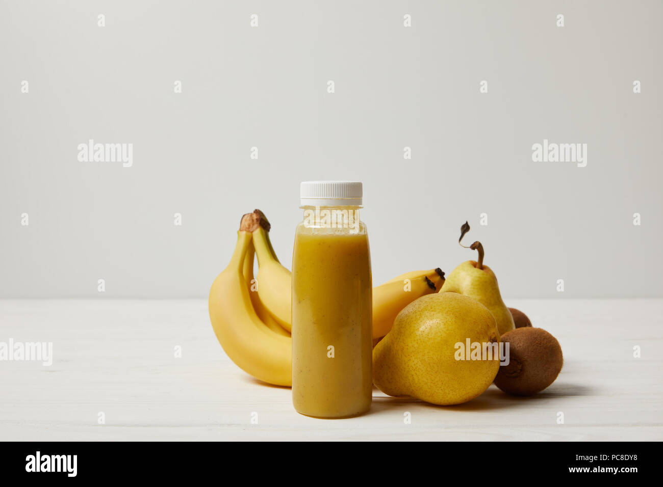 yellow smoothie with bananas, kiwis and pears on white background Stock ...
