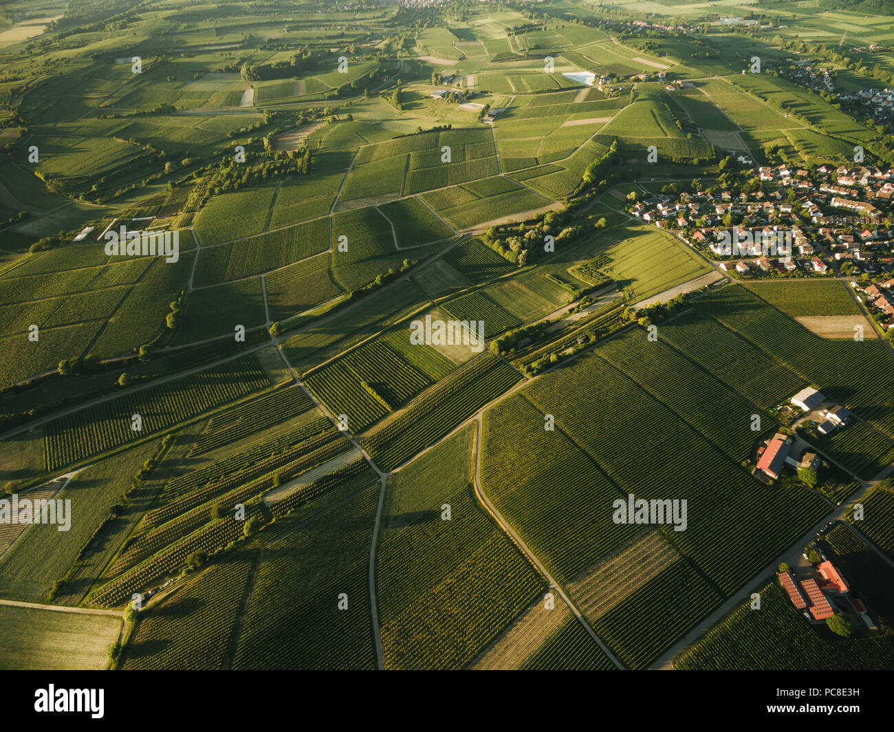 aerial view of village surrounded with agricultural fields, europe ...