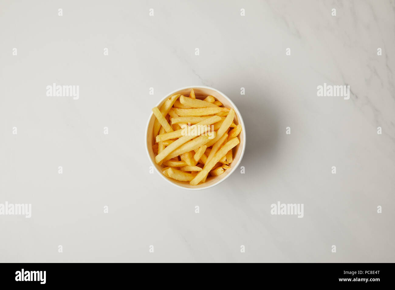 top view of bowl of french fries on white Stock Photo - Alamy