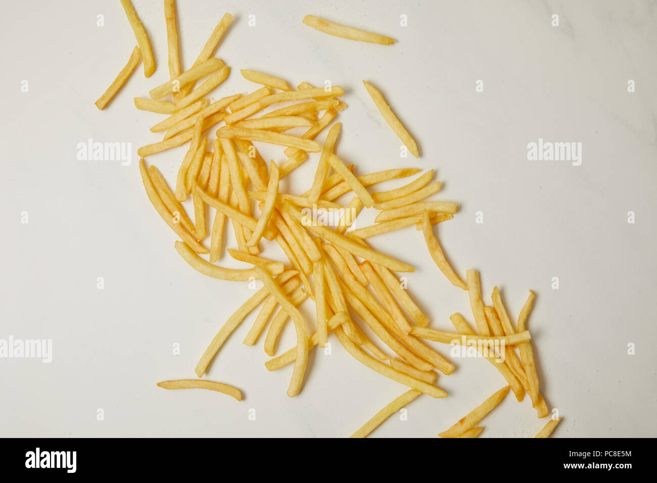 top view of french fries spilled over white surface Stock Photo - Alamy