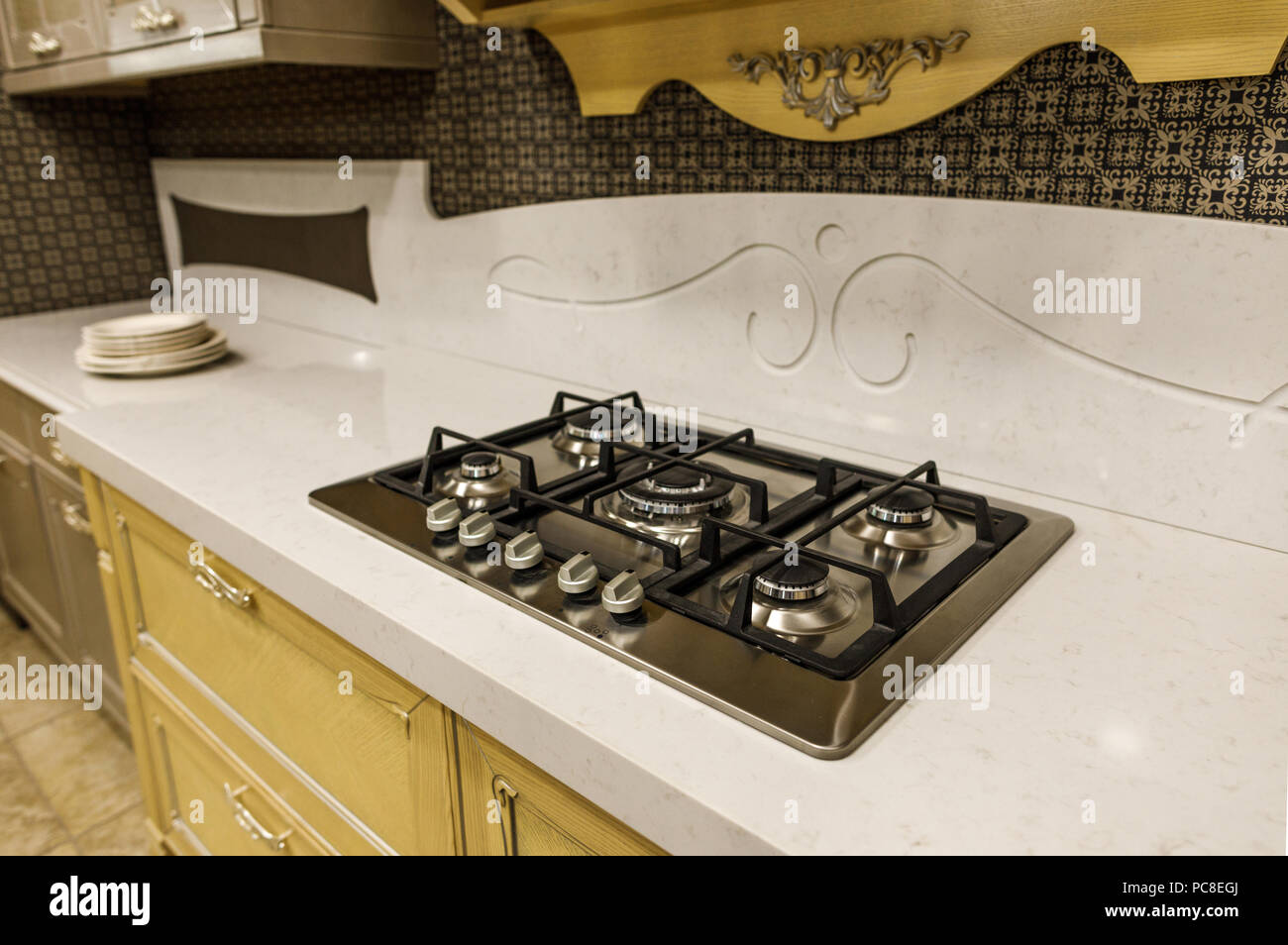 Stylish kitchen with stove on white counter Stock Photo - Alamy