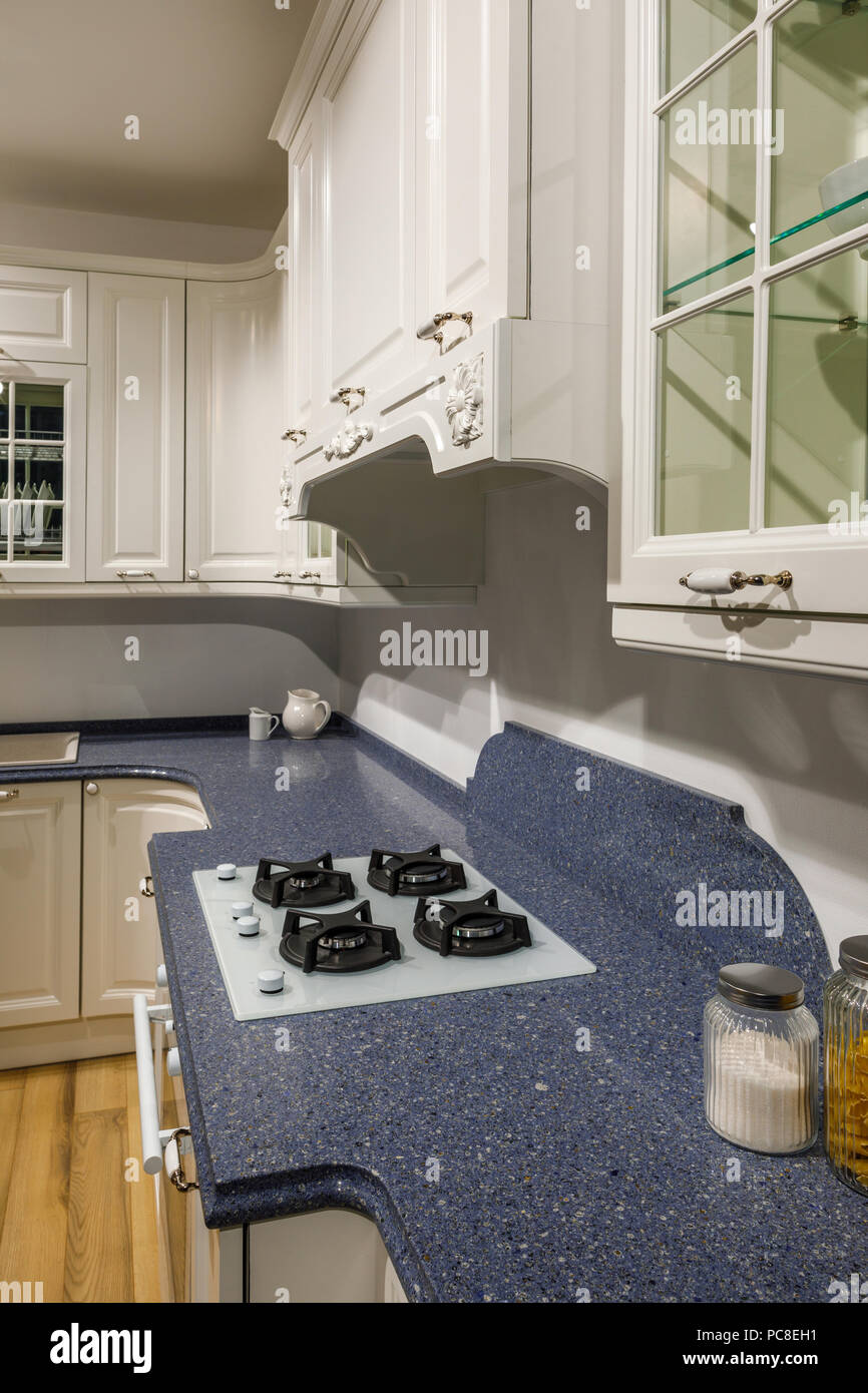 Stylish kitchen with elegant stone counter and stove Stock Photo - Alamy