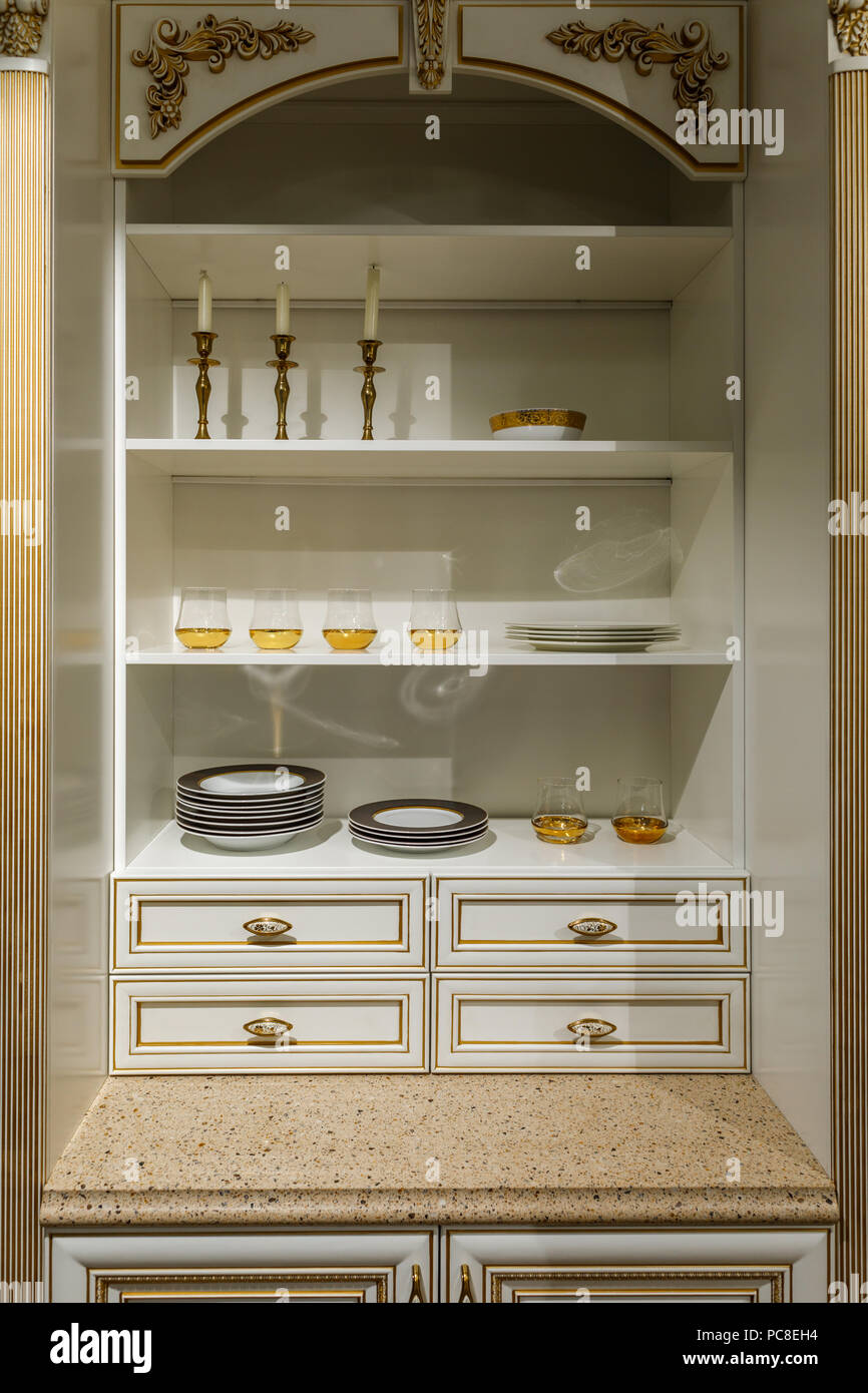 Interior of modern kitchen with elegant tableware in cupboard Stock ...