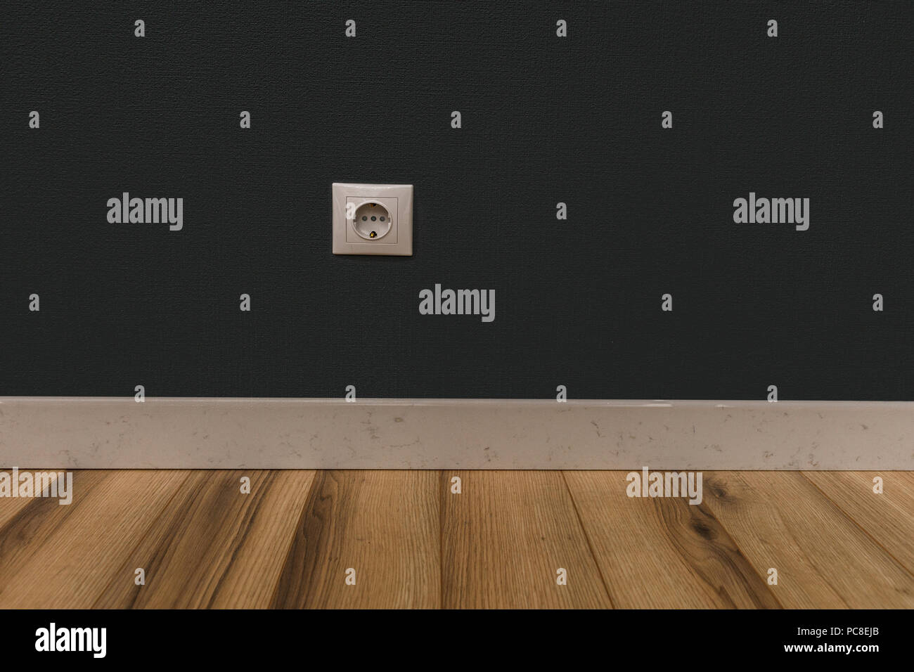 Single power socket in empty wall over wooden floor Stock Photo - Alamy