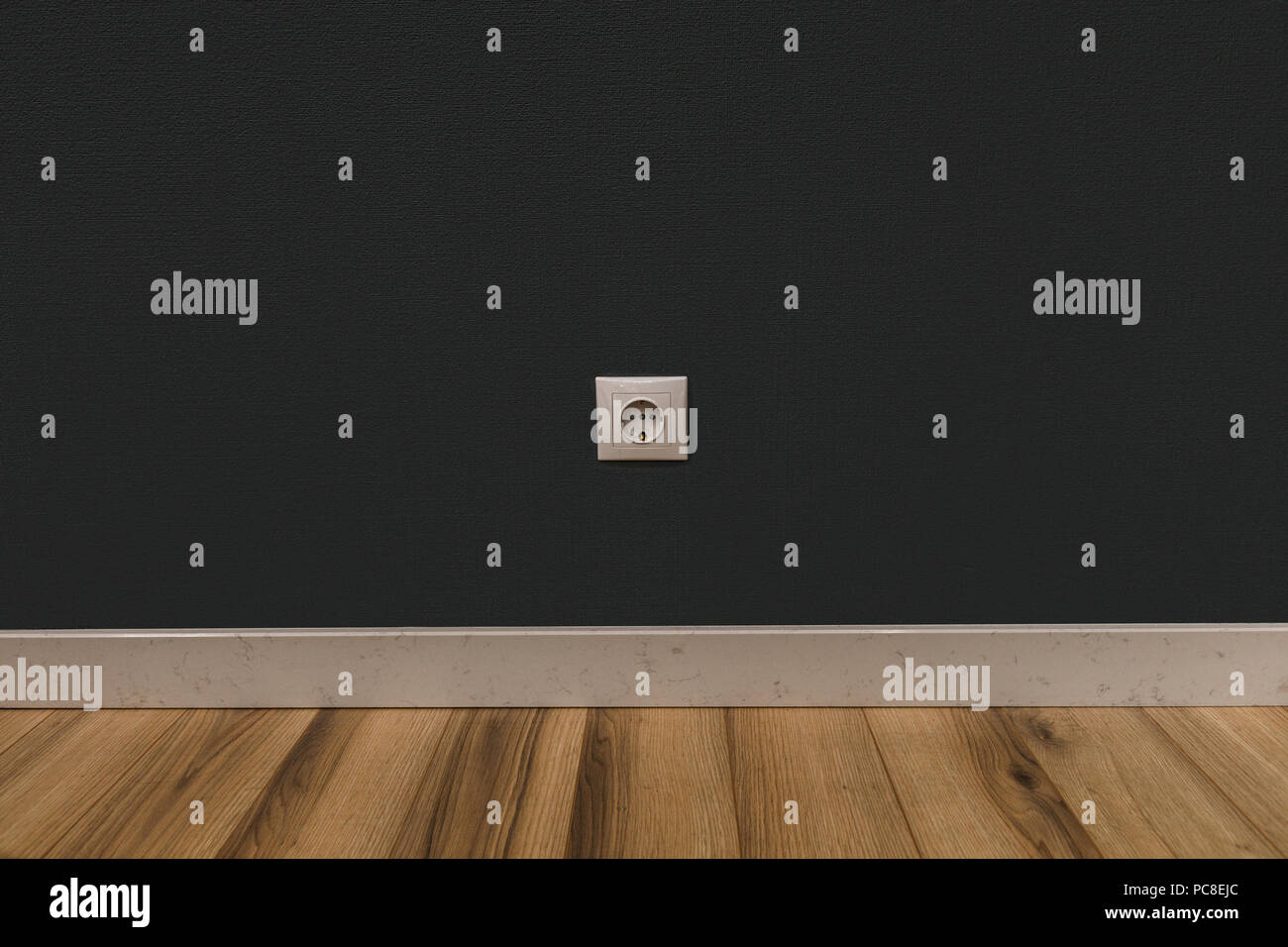 Single power socket in dark wall over wooden floor Stock Photo - Alamy