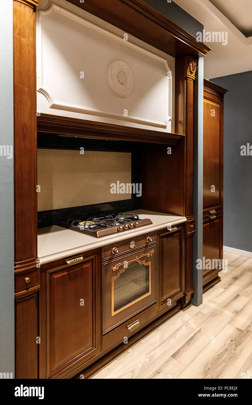 Stylish kitchen with elegant wooden counter and stove Stock Photo - Alamy