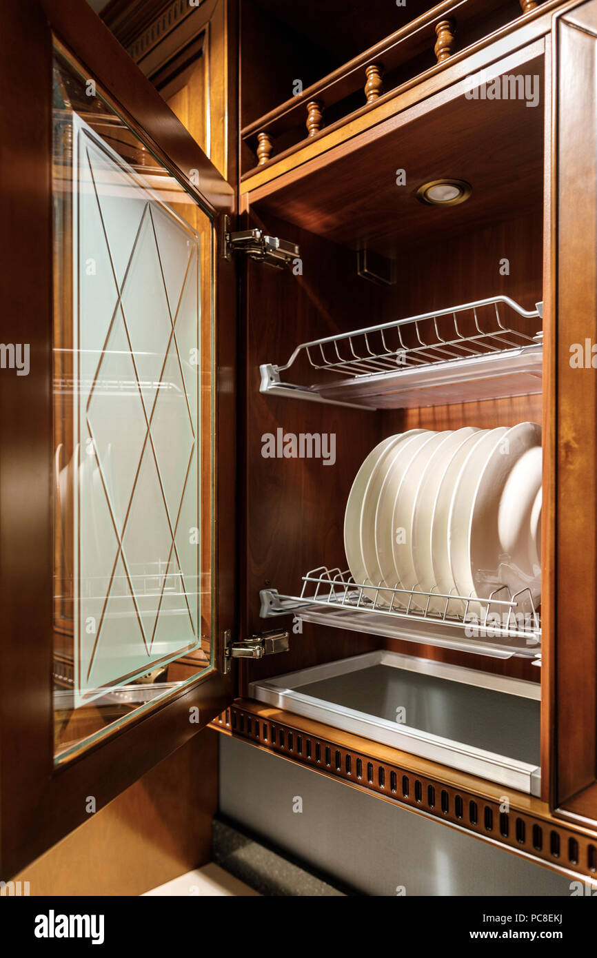 Stylish kitchen with white plates in cupboard Stock Photo - Alamy
