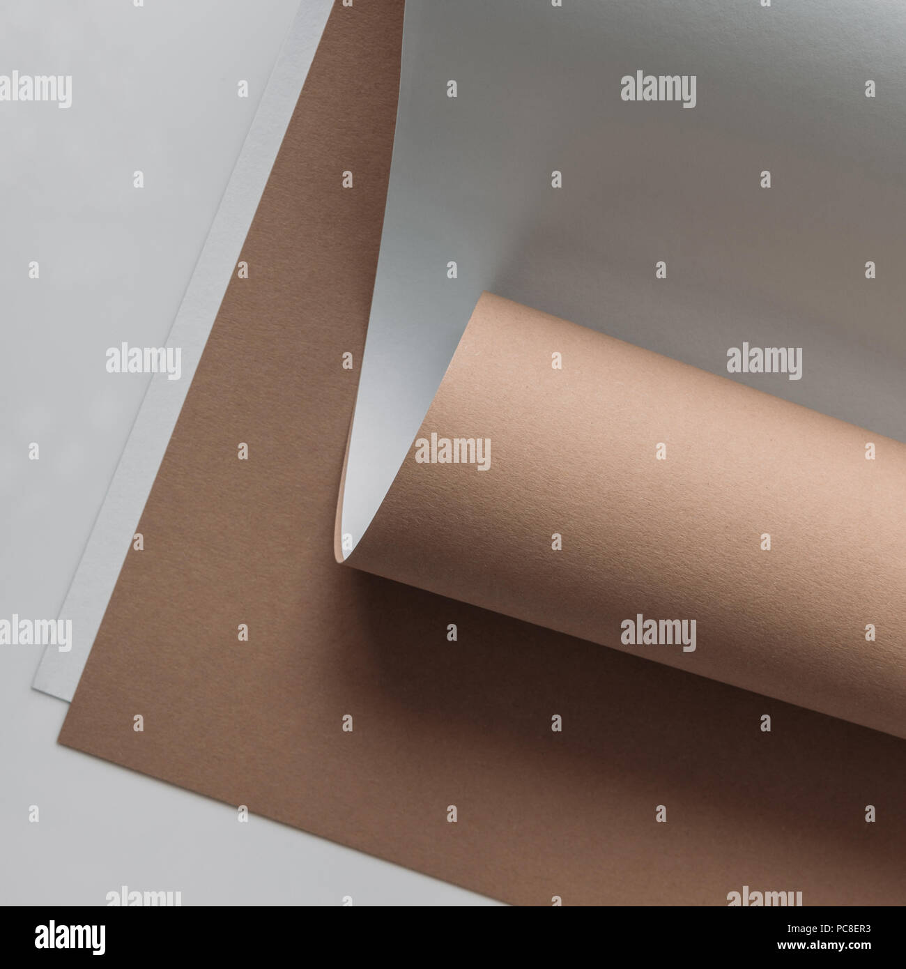 white and brown paper sheets on grey background Stock Photo - Alamy